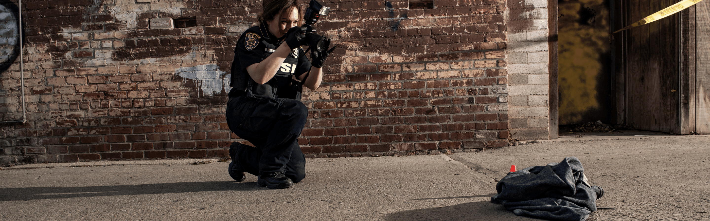 a tracy police department crime scene investigator takes a photo ...