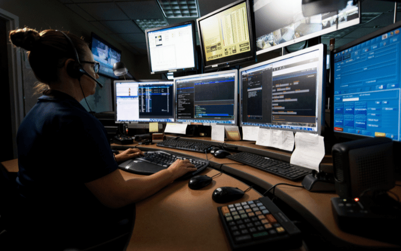 a tracy police department dispatcher monitors the radio and computers ...